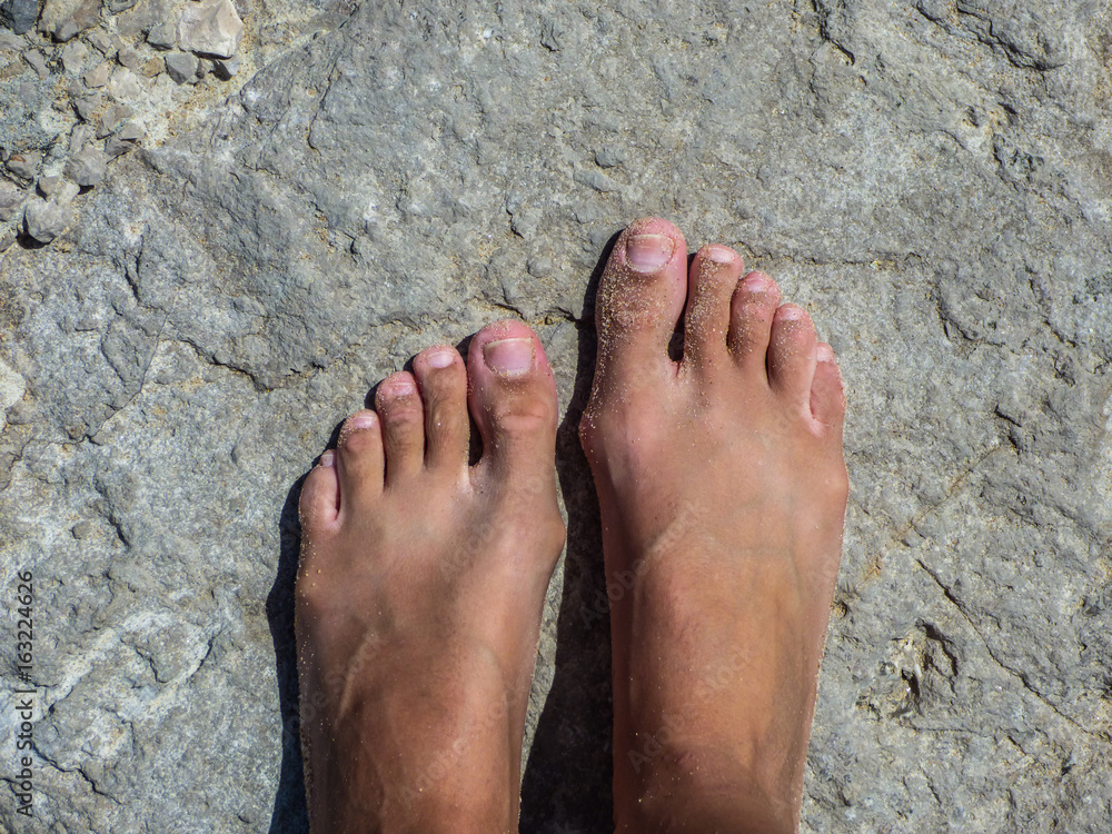 Sandy feet on a rock Stock Photo | Adobe Stock