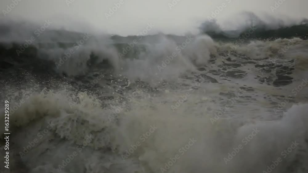 Storm waves line up then crash onto a rocky shoreline South Africa ...