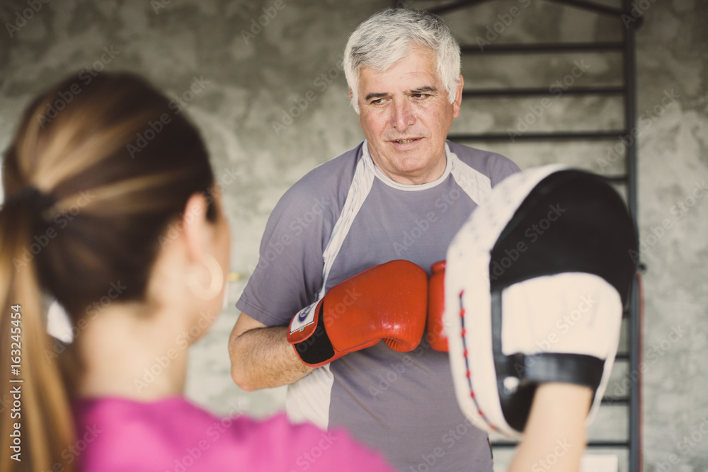 Older man boxing in gym. Senior man with personal trainer. Stock Photo ...