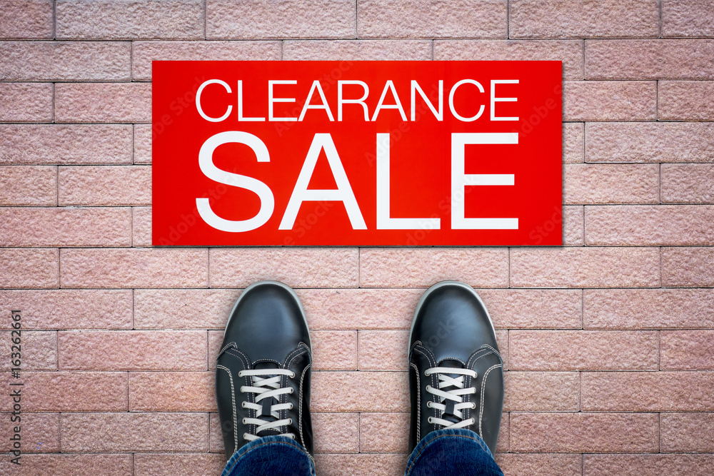 Black shoes standing on tiled brick floor with clearance sale ...