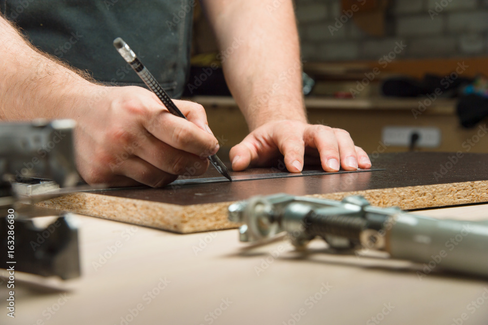 Male hands draw a pencil on the ruler Stock Photo | Adobe Stock
