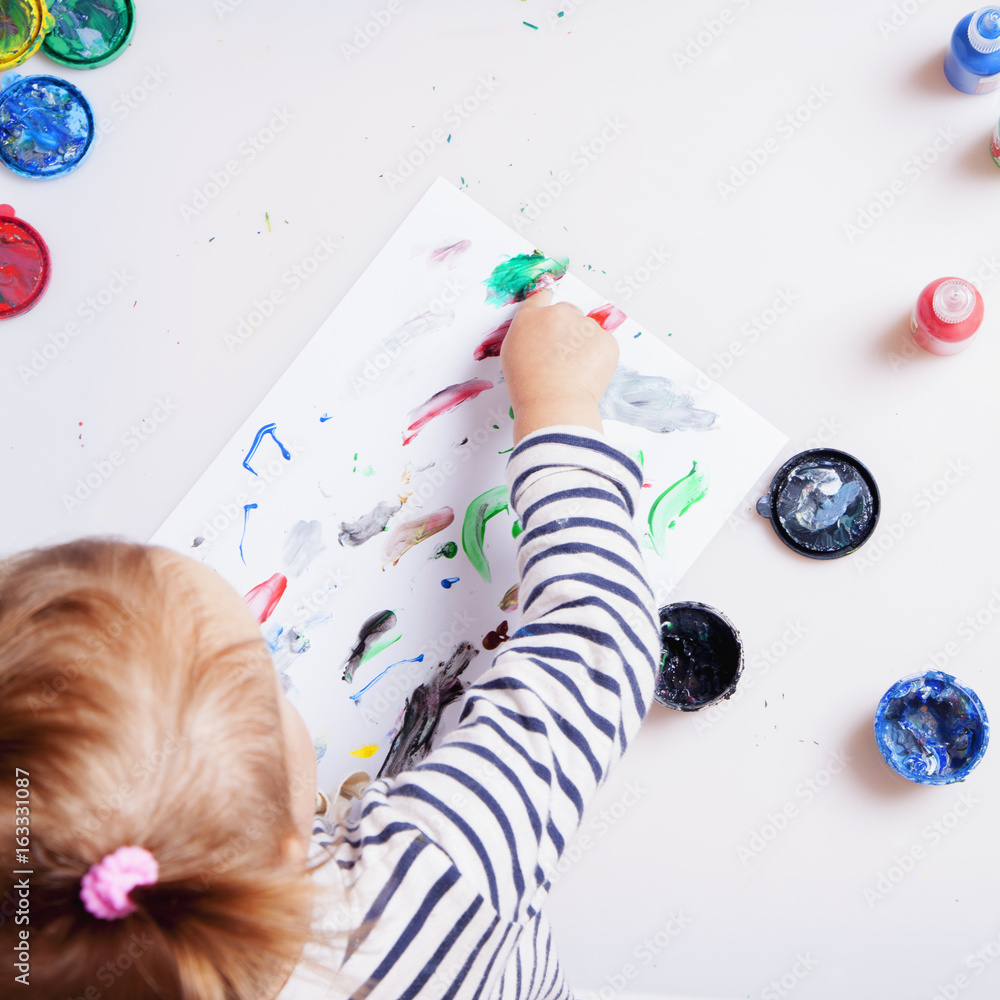 little girl learning to paint (child development in art concept) Stock ...