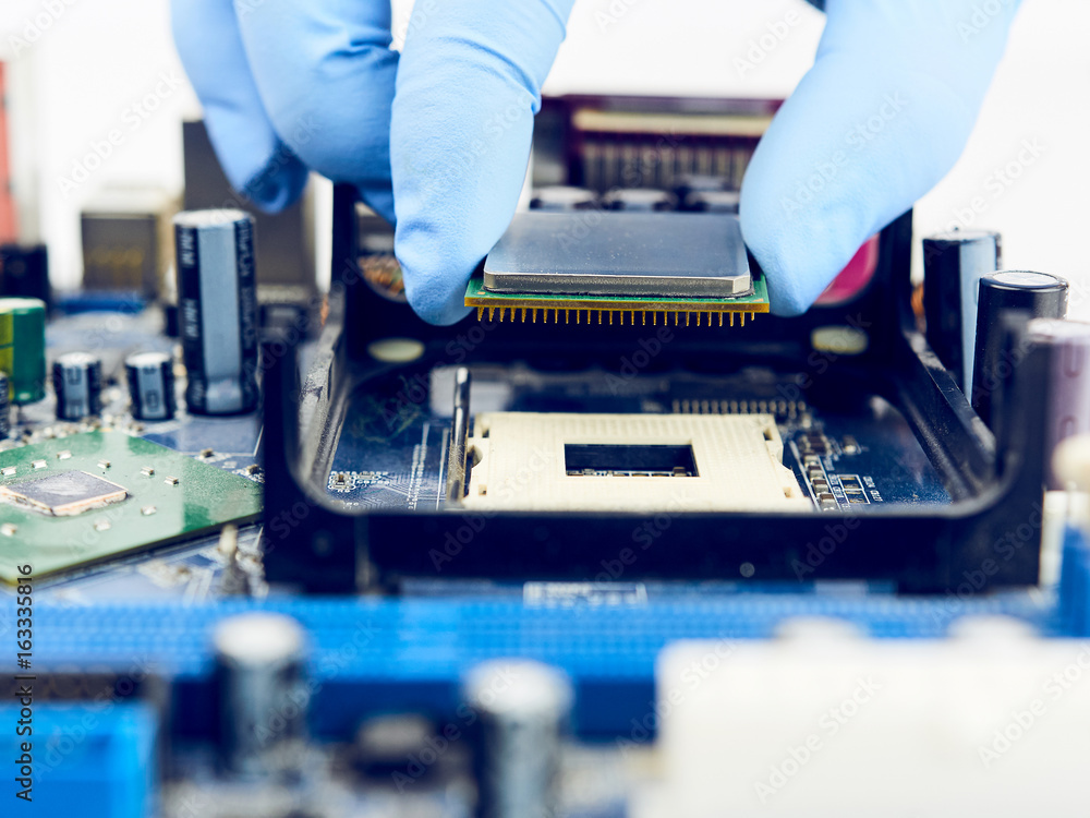 Hand With Plastic Gloves Installing CPU Chip On Motherboard Closeup ...