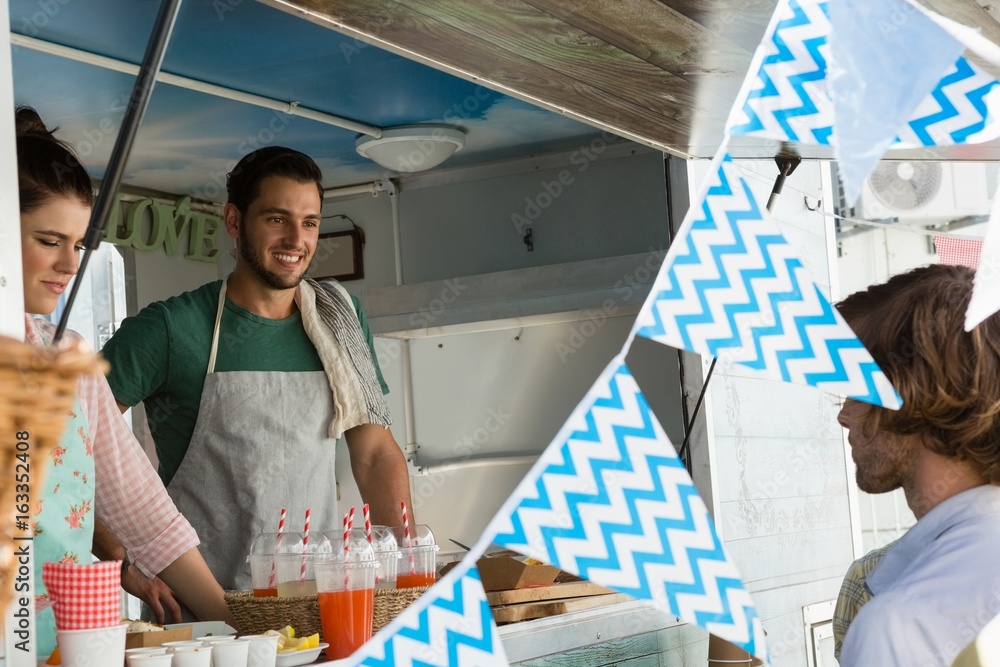 Customer buying food at truck Stock Photo | Adobe Stock