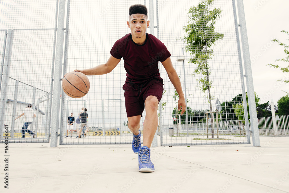 Man running with basketball Stock Photo | Adobe Stock