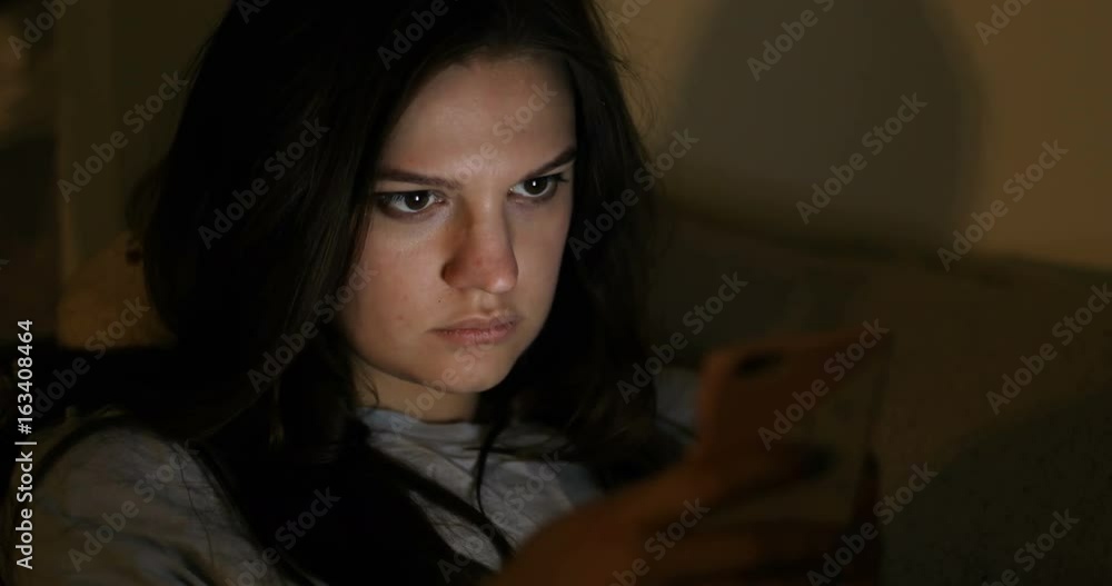 Young woman using mobile phone in dark room at home late Stock Video ...