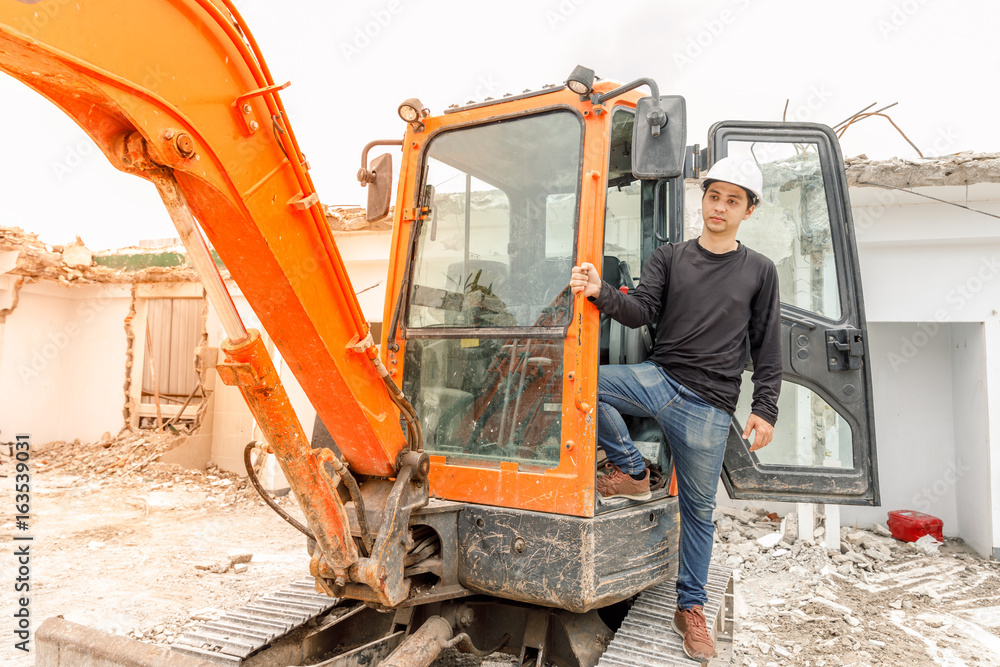 Asian man standing with Backhoe Robot Equipment on construction zone ...