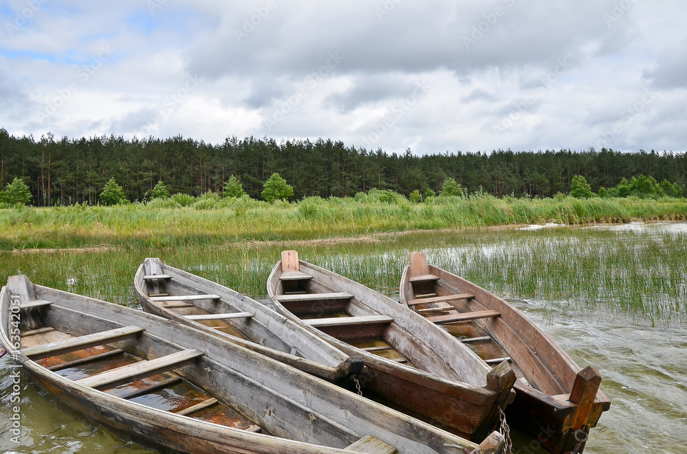 Old rustic wooden fishing boats on the lake at stormy weather, close up ...