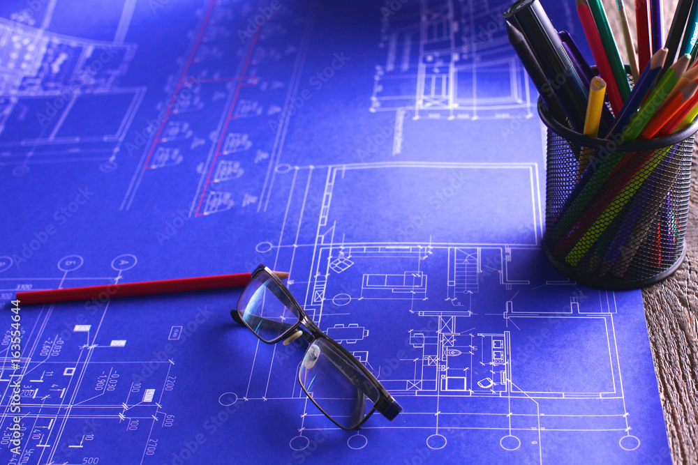 Architectural blueprints and blueprint rolls and a drawing instruments ...