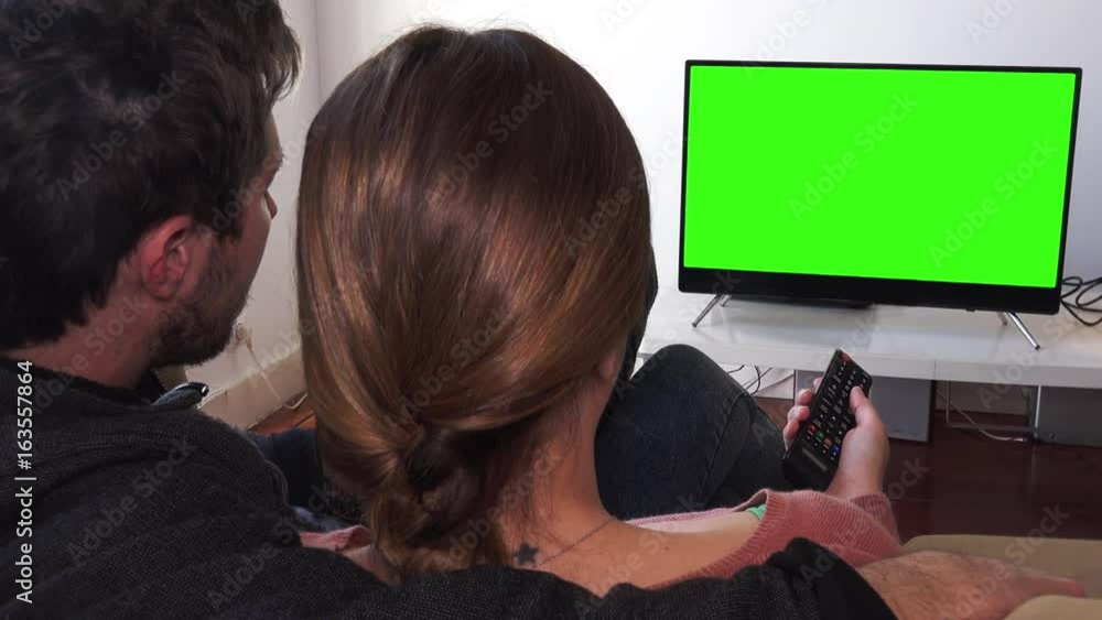Stockvideo Couple Watching TV Green Screen, Girl Changing Channels With ...