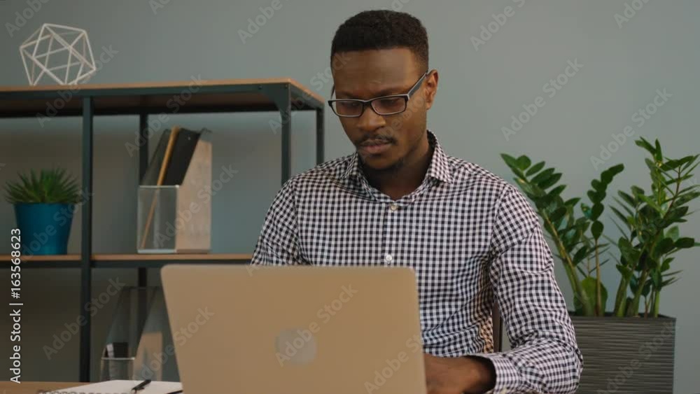 African american business man using laptop computer at the office ...