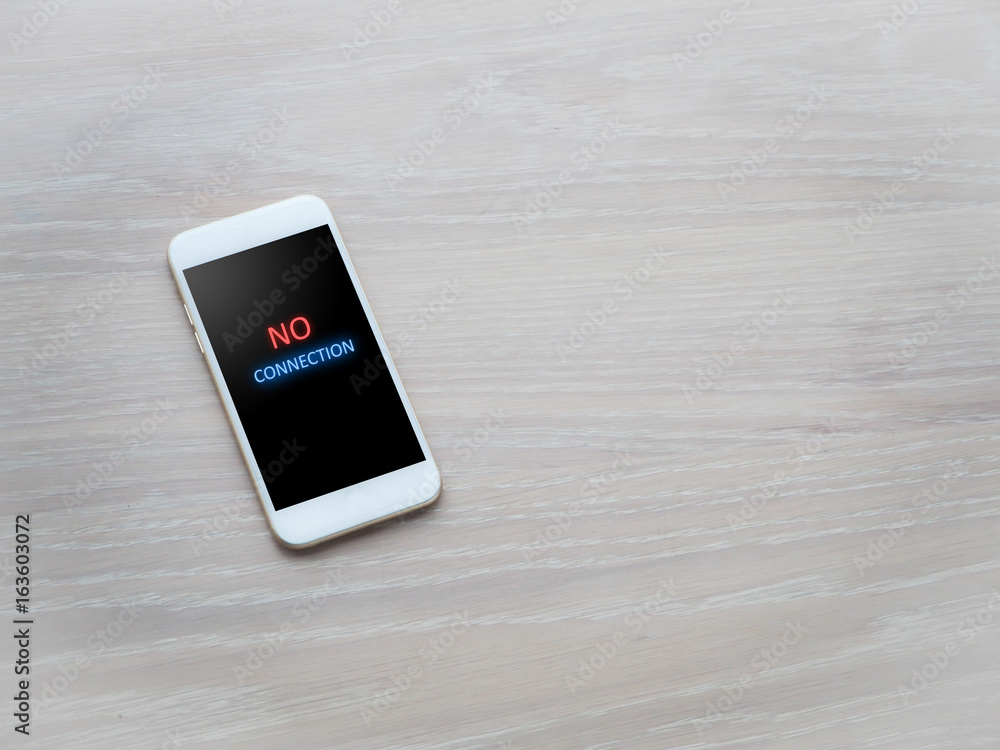 Office table with no connection message on cell phone screen. Stock ...