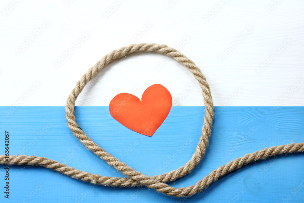 Love loop trap/ Installation of a thick rope around the symbol of the ...