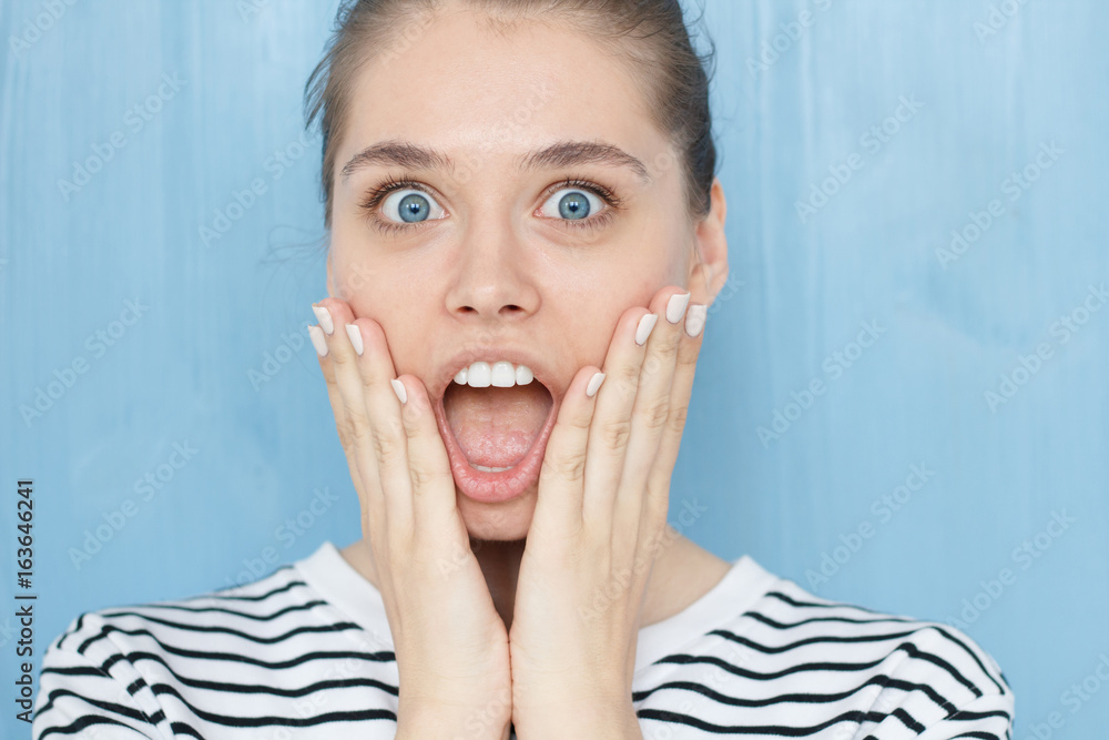 Cute young caucasian female in navy striped t-shirt with opening mouth ...
