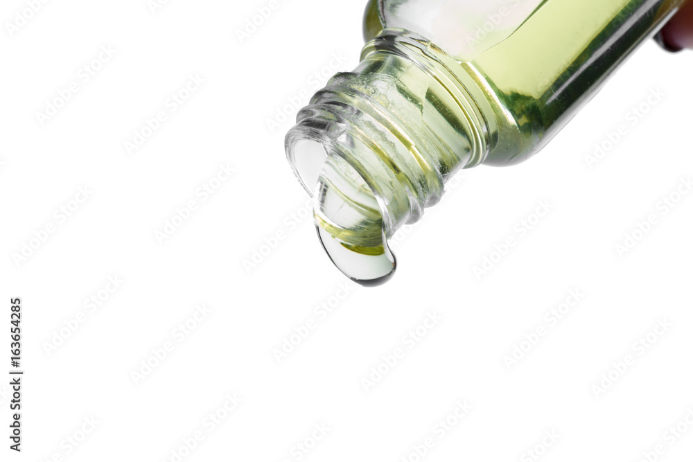 Cosmetic liquid pouring from bottle isolated on white background Stock ...