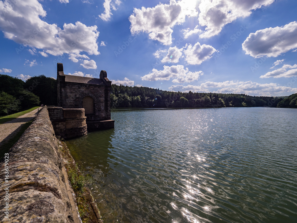 Linacre Reservoir with Wall Building Direct Sunlight and Blue Sky with ...