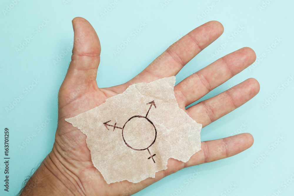 Symbol of a transgender in an open hand on a blue background. Stock ...