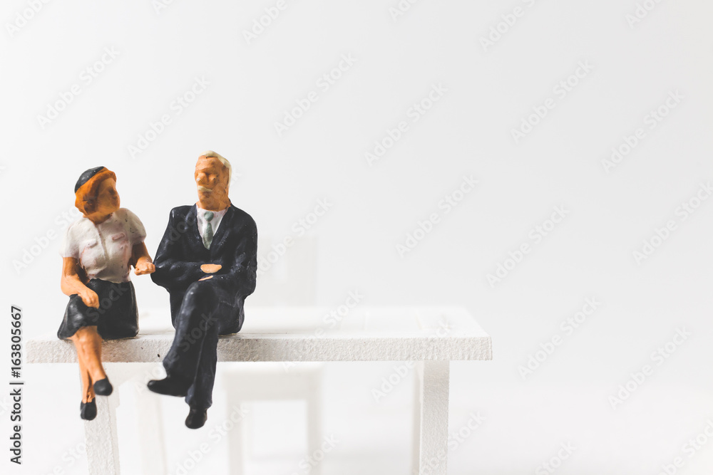 Miniature people business concept sitting on chair with a space for ...