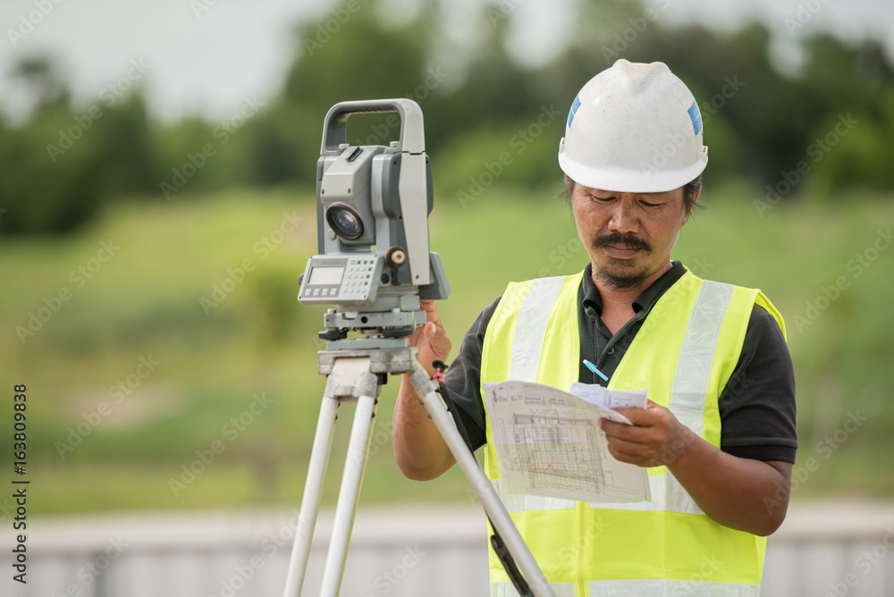 survey engineer in construction site use theodolite mark a concrete ...