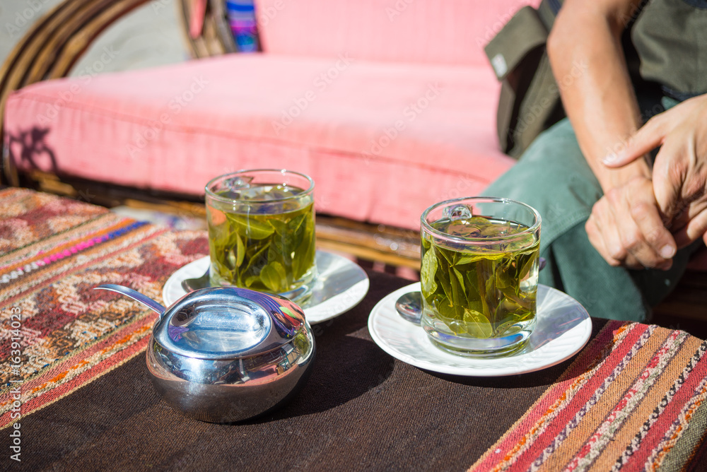 Tea cups with Coca leaves infusion known as "Mate de Coca", typical ...