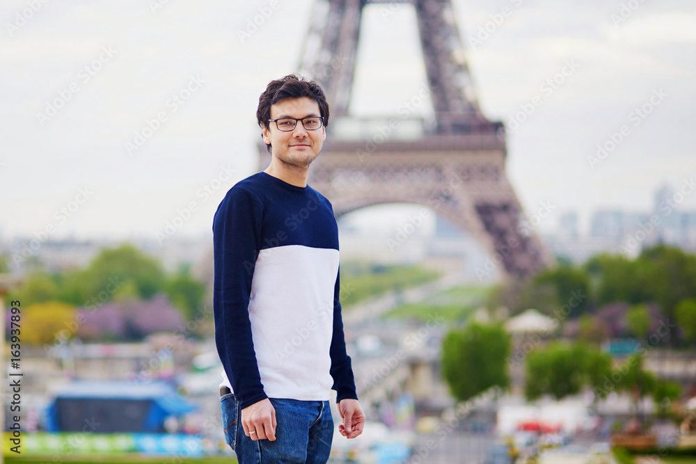 Man in Paris in front of the Eiffel tower Stock Photo | Adobe Stock