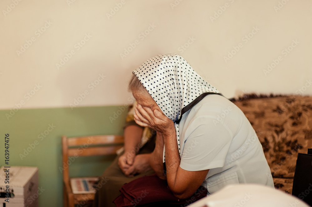 Old woman crying covering her face with her hands Stock Photo | Adobe Stock