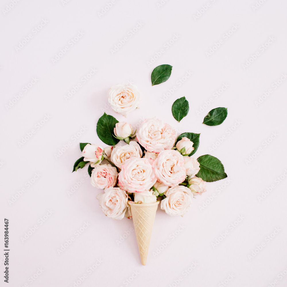 Waffle cone with pink bombastic roses bouquet on pale pastel pink ...