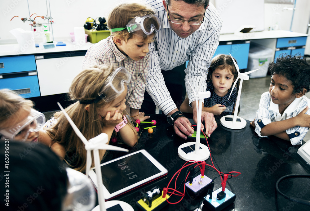 Teacher hands turning on solar windmill energy produce switch in ...