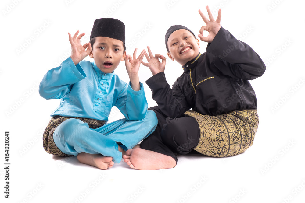 Portrait of little boys posing at studio with traditional malay clothes ...