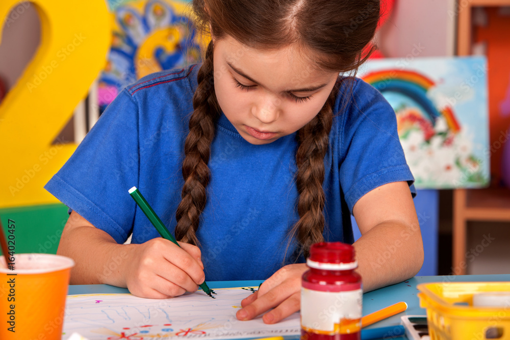 Small student girl painting in art school class. Child drawing by ...