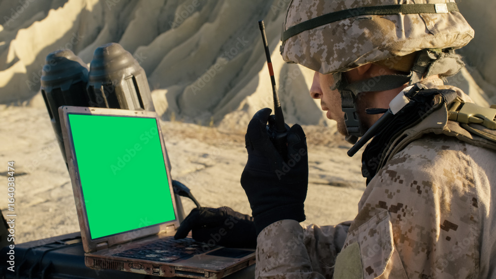 Soldier is Using Laptop Computer with Green Screen and Radio for ...