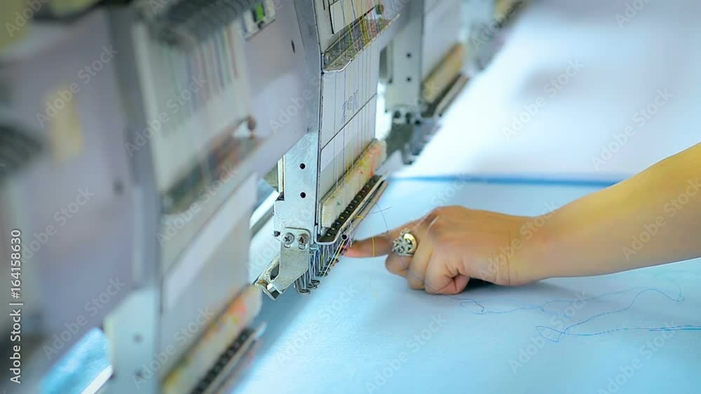 Close-up a employee of a garment factory works in the shop for sewing ...