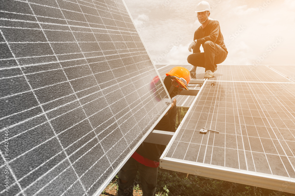 engineer or electrician working on replacement solar panel at solar ...