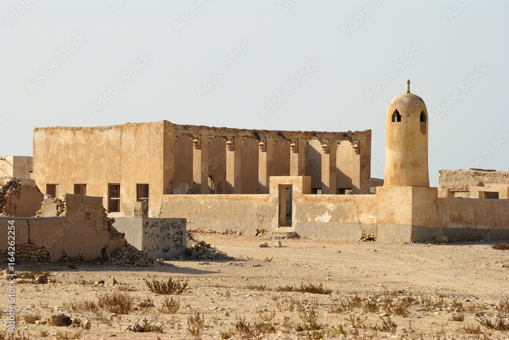 Ruins of abandoned village Al-Jumail in Qatar, with minaret of ruined ...