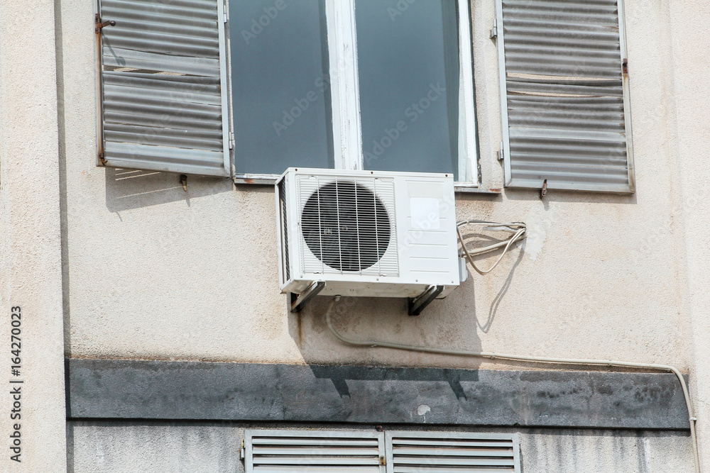 Air conditioning, exterior unit on the facade of the old building ...