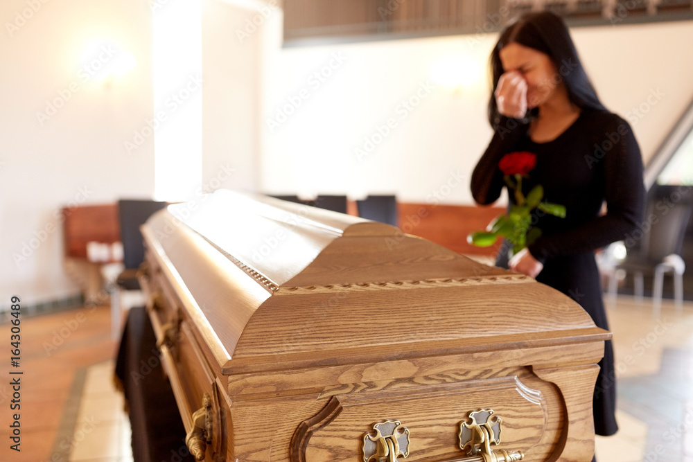 woman with coffin crying at funeral in church Stock Photo | Adobe Stock