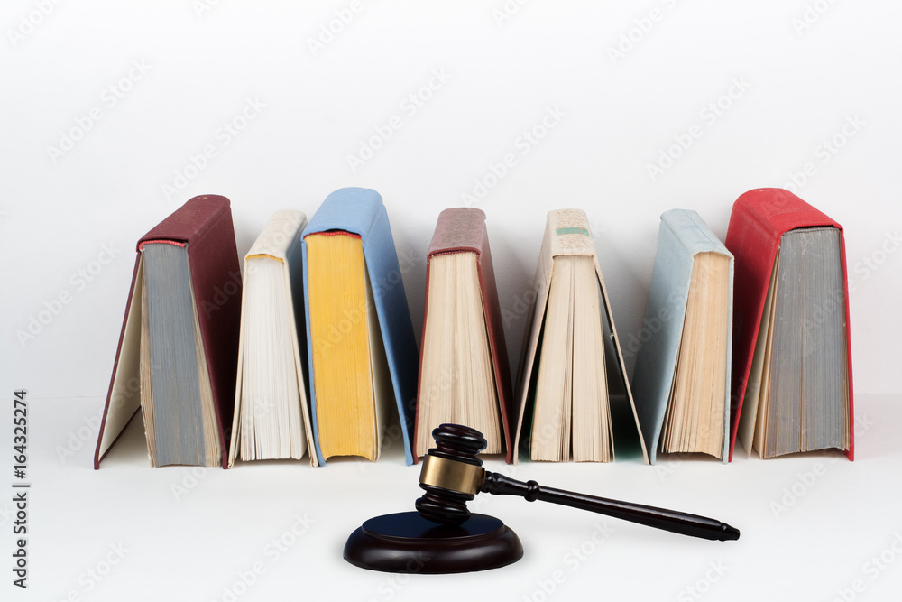 Law concept open book with wooden judges gavel on table in a courtroom ...