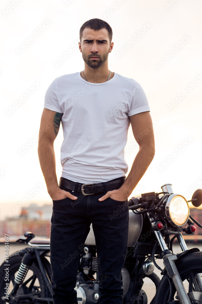 Close up of a handsome rider man in white blank t-shirt look to camera ...