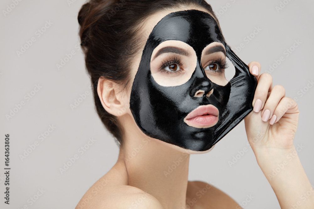 Woman Face Mask. Closeup Beautiful Girl Removing Black Mask Stock Photo ...