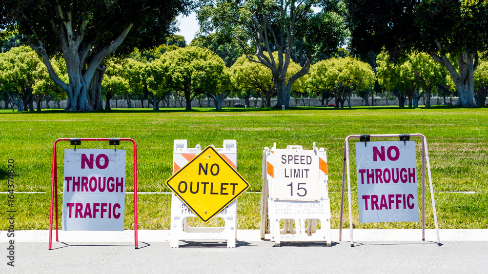 4 competing road signs in a park Stock Photo | Adobe Stock