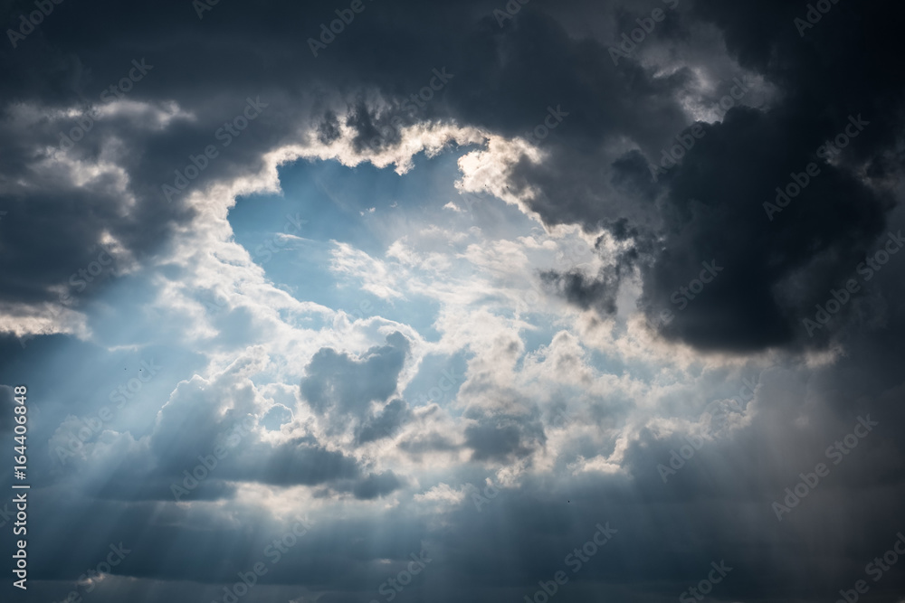 sun rays shining through dark clouds after strom Stock Photo | Adobe Stock
