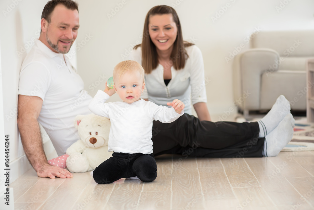 Happy family of three is enjoying at home. Parents and their beautiful ...
