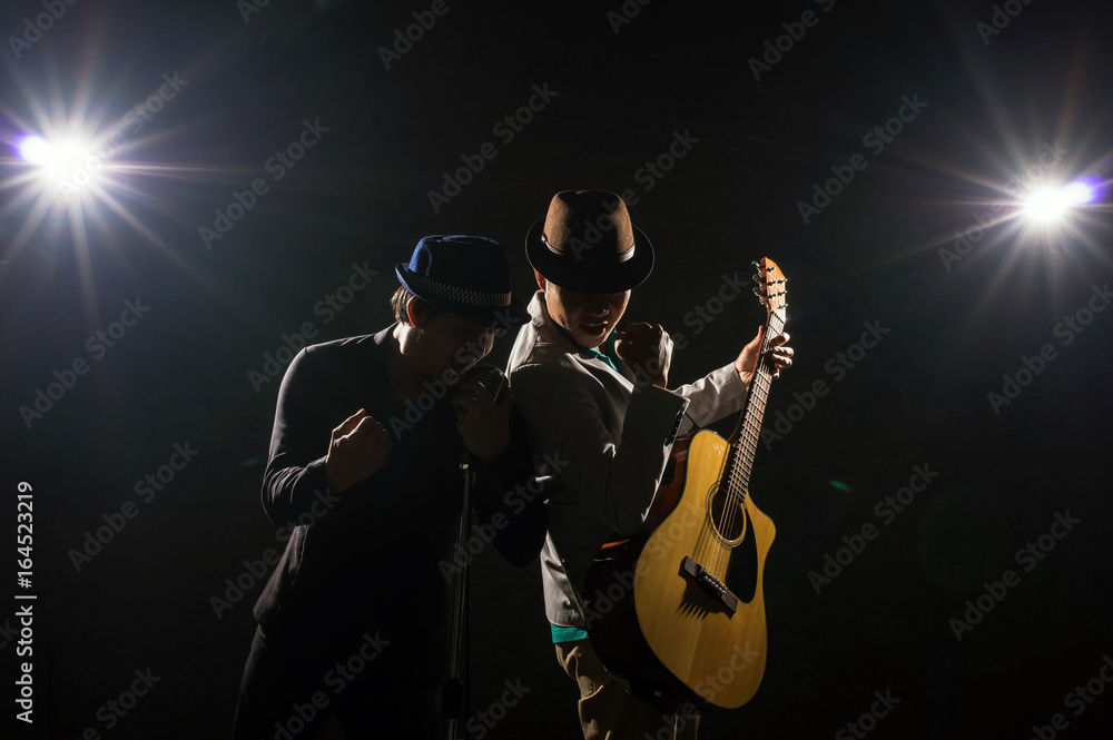 Musician Duo band hand holding the microphone and singing a song and ...