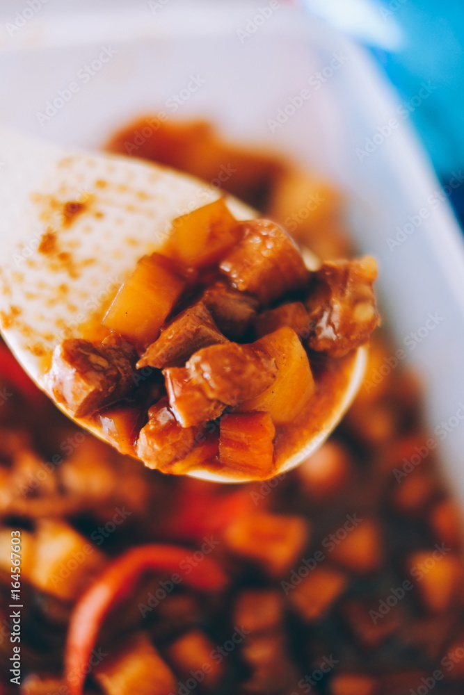 Menudo Filipino food, pork meat and vegetables with tomato sauce ...