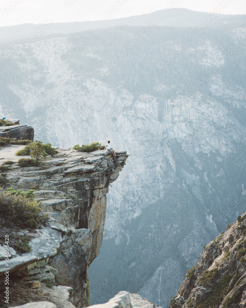 Man Sitting on Ledge Stock Photo | Adobe Stock