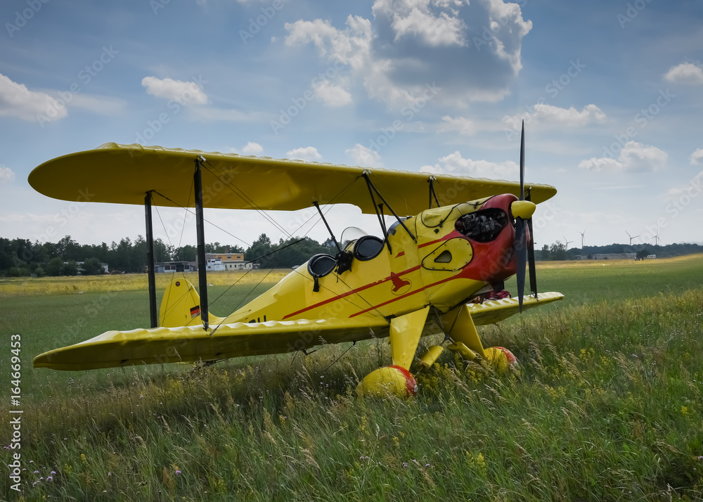 Light aircraft. Light yellow airplane on airport grass. Light general ...