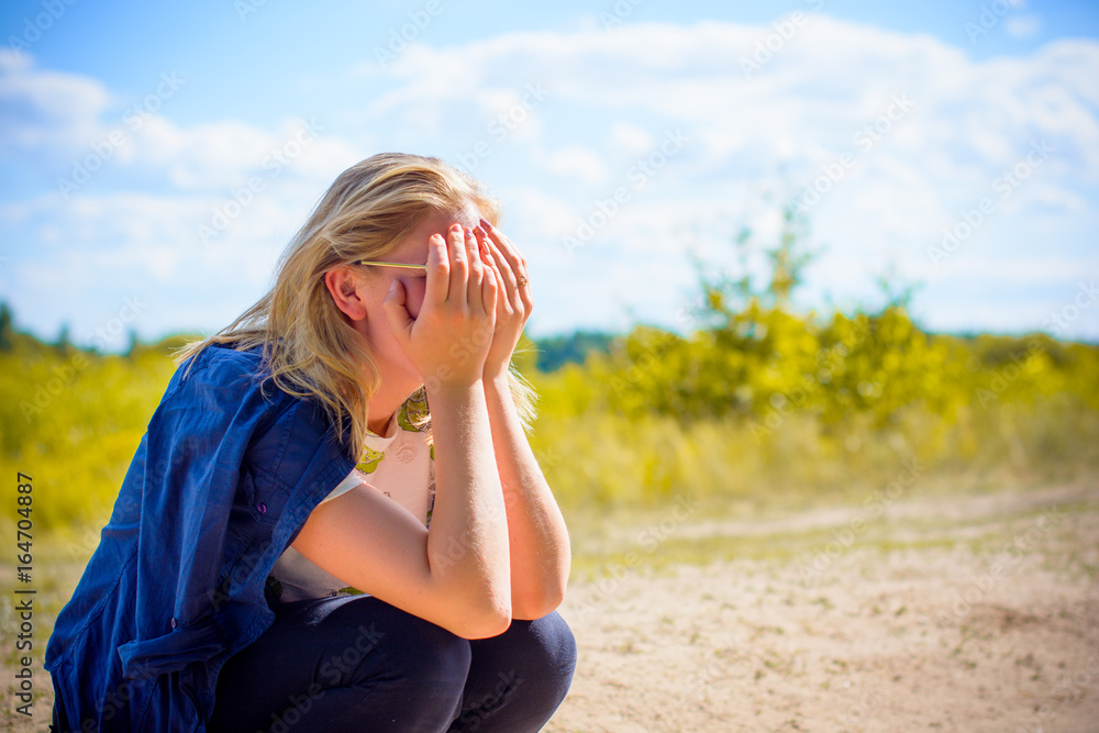 Young stressed woman having trouble on a road. Worry girl in field ...