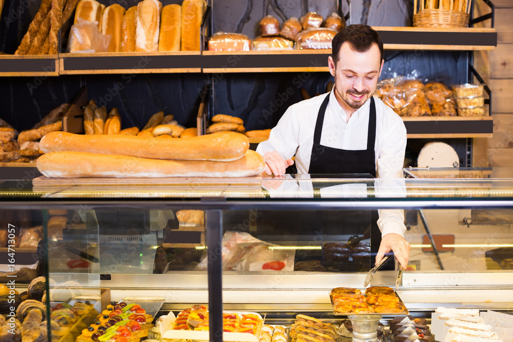 Man shows the delicious pastries and cakes Stock Photo | Adobe Stock
