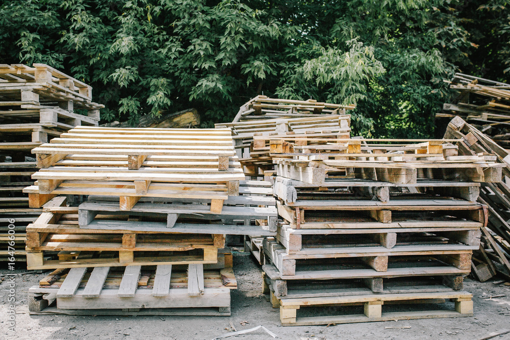 Used worn wooden pallet dumped at the yard. Stock Photo | Adobe Stock