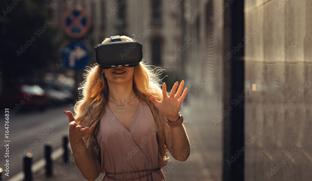 Interested blonde woman trying new VR technology, the ultra high-tech ...